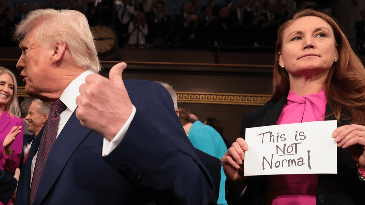 Moment 'this is not normal' sign is ripped out of woman's hand and ...