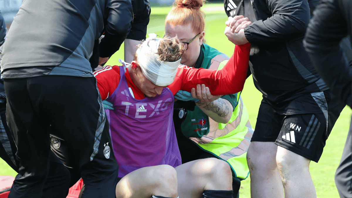 Footballer left covered in blood after being hit by a seat thrown by ...