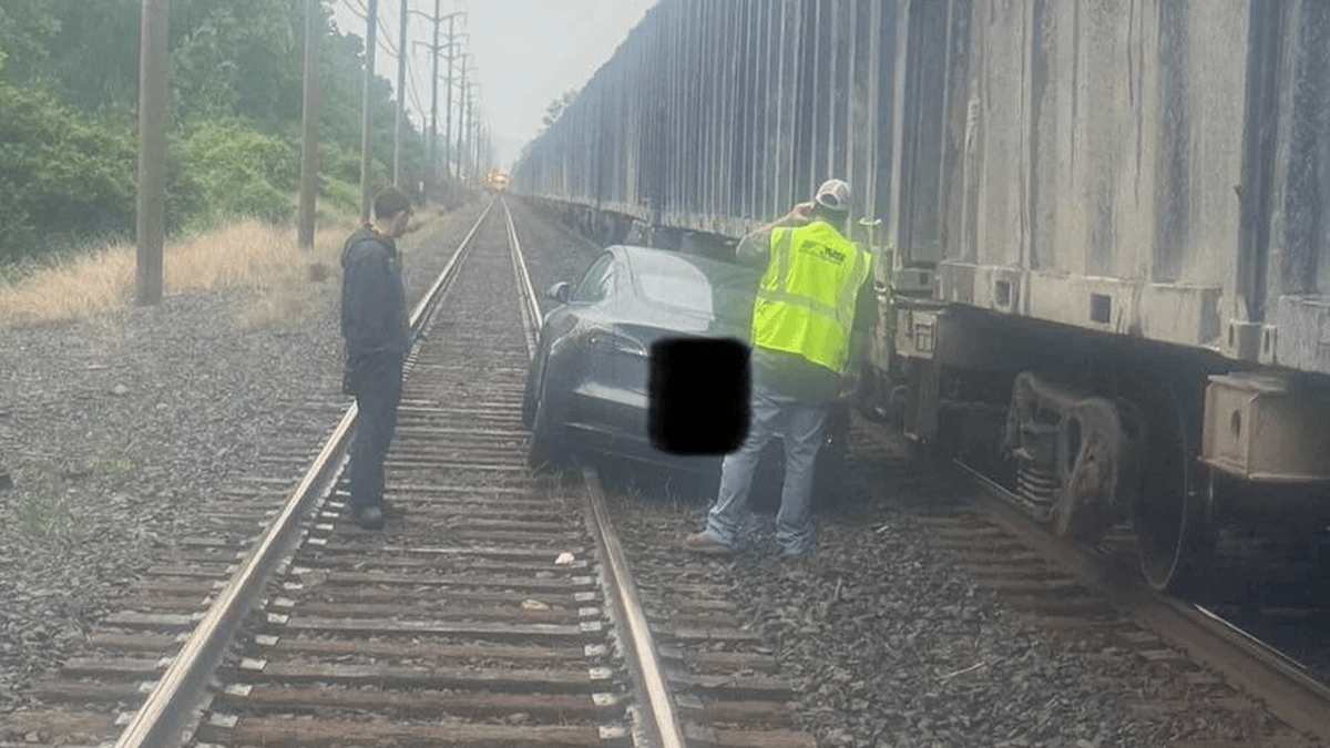 Shocking photographs show Tesla hit by train after self-driving error ...